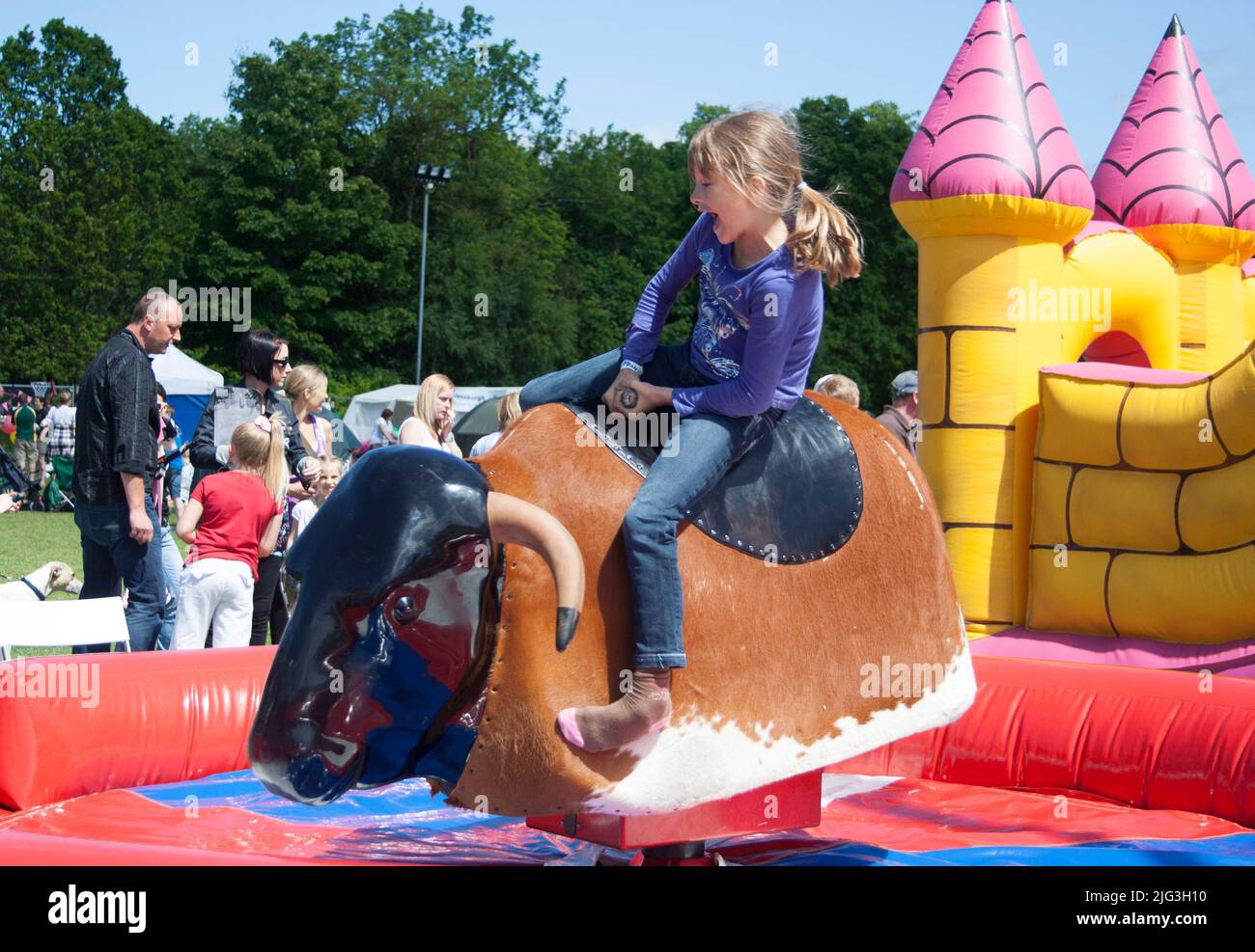 Girl on Bucking Bronco at the Highland Games fair, Helensburgh ...
