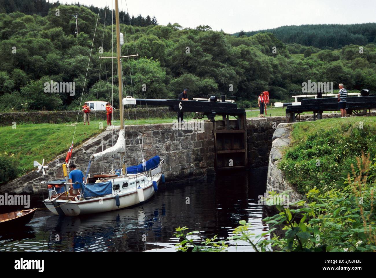 yacht going through the Cairnbaan Lock on the Crinan Canal, Argyll and ...