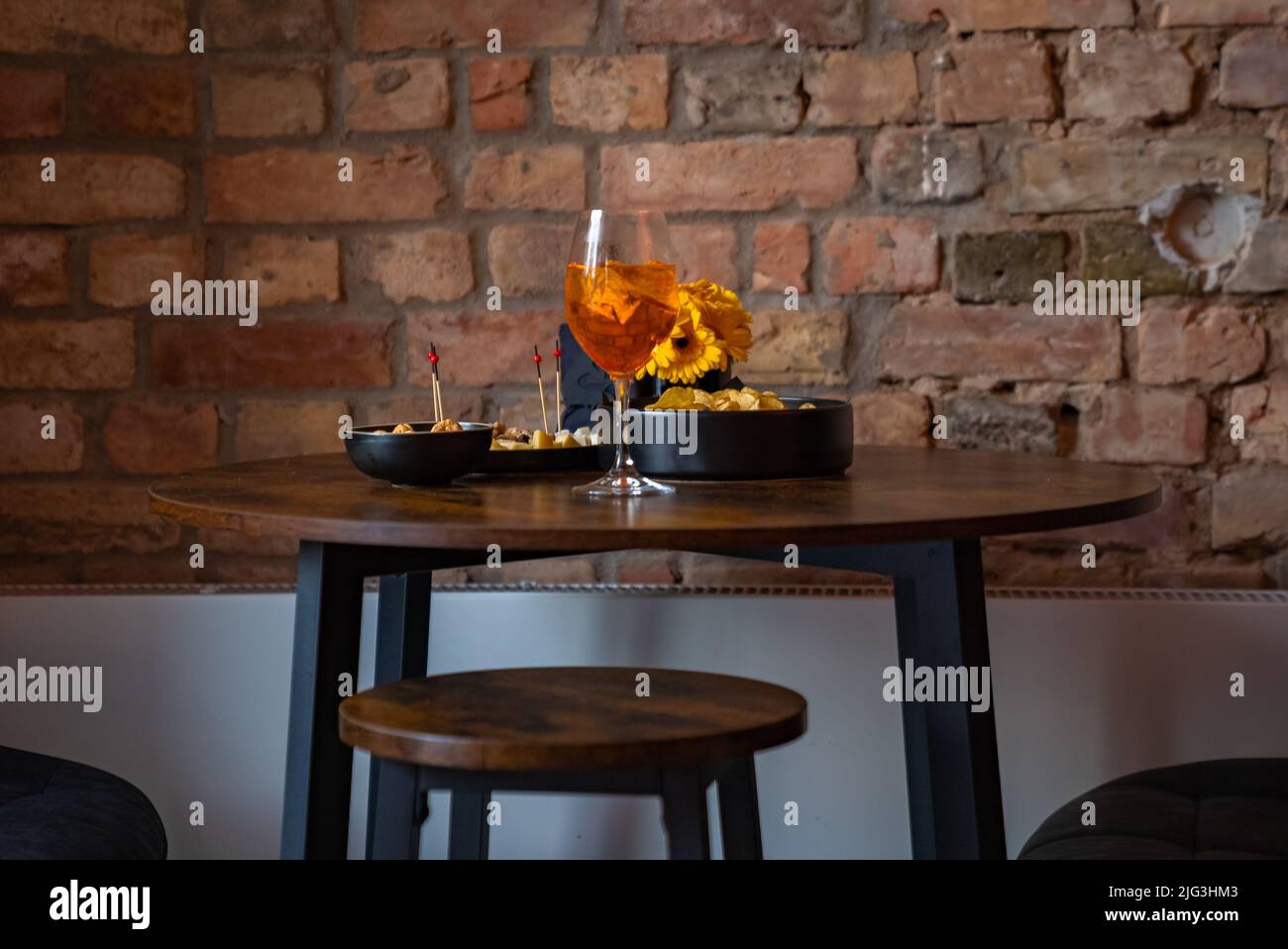 Traditional italian aperitif with cheese, nuts and aperol spritz drink ...