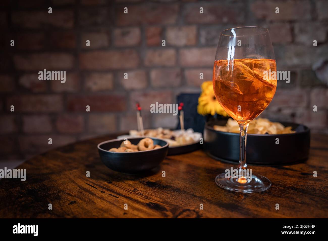 Traditional italian aperitif with cheese, nuts and aperol spritz drink ...