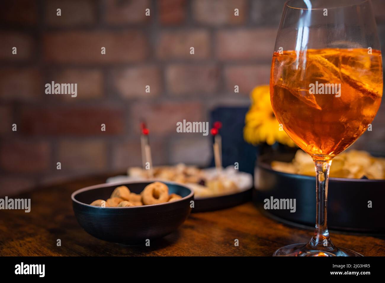 Traditional italian aperitif with cheese, nuts and aperol spritz drink ...
