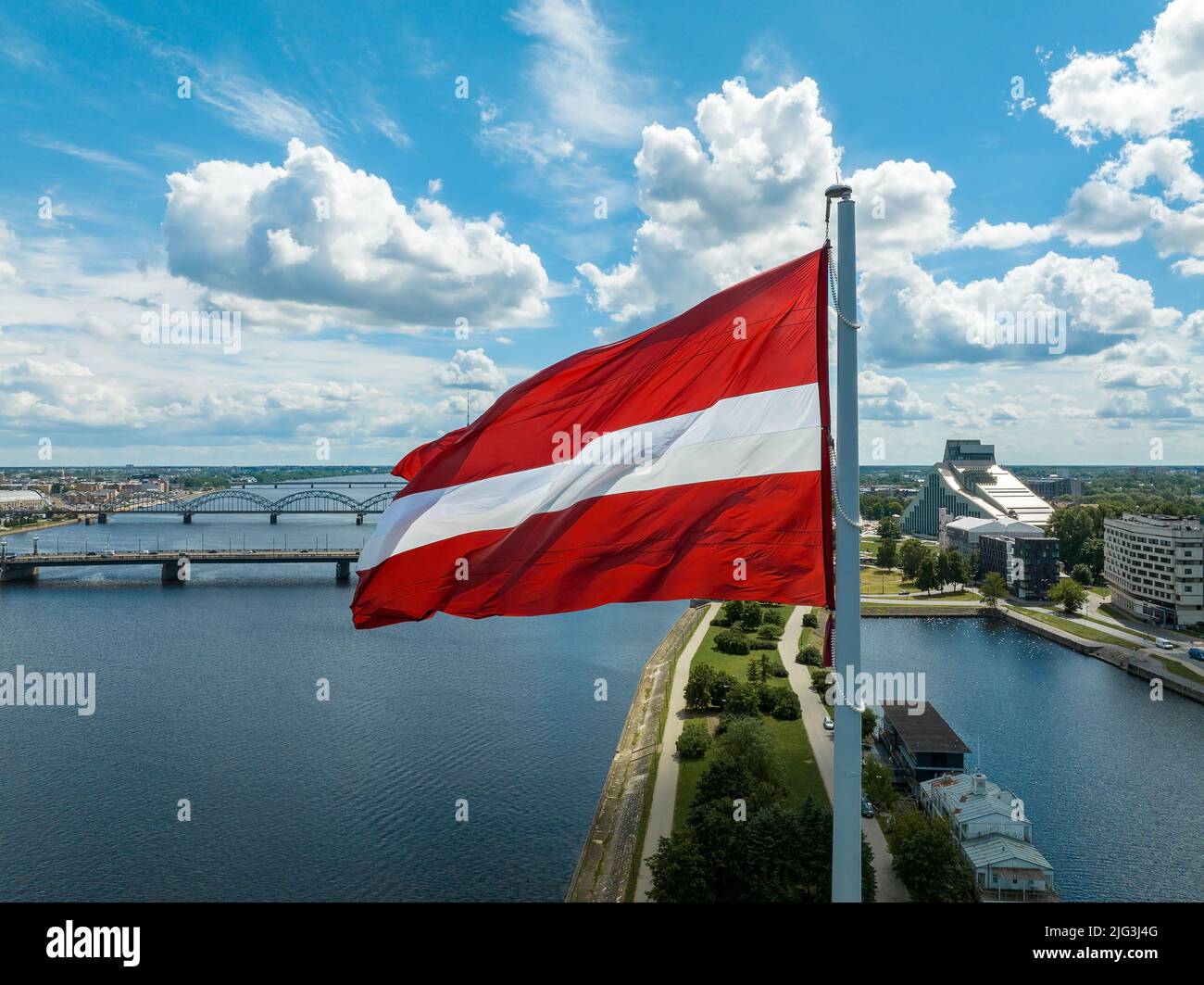 Latvian flag with the Dome Cathedral and national library in the background Stock Photo - Alamy