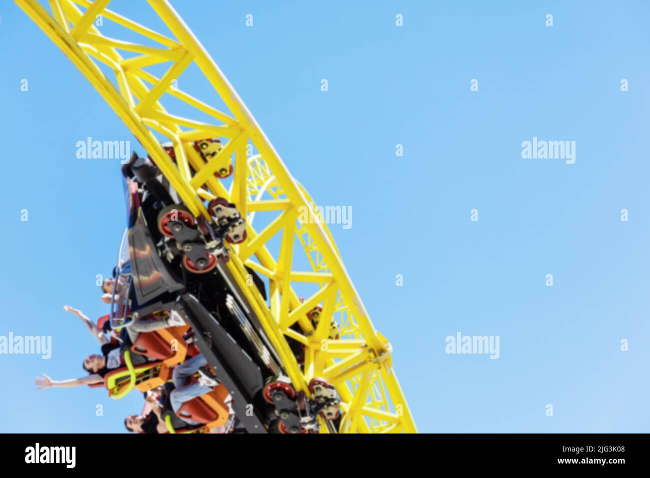The people in the trolley ride the roller coaster. Extreme attraction ...