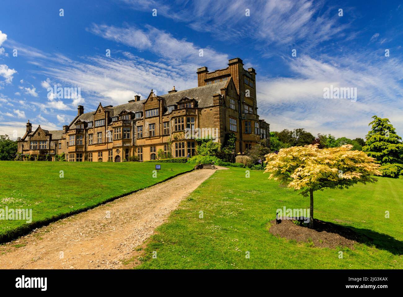 Sunlight brightens the south front of Minterne House and miniature acer ...