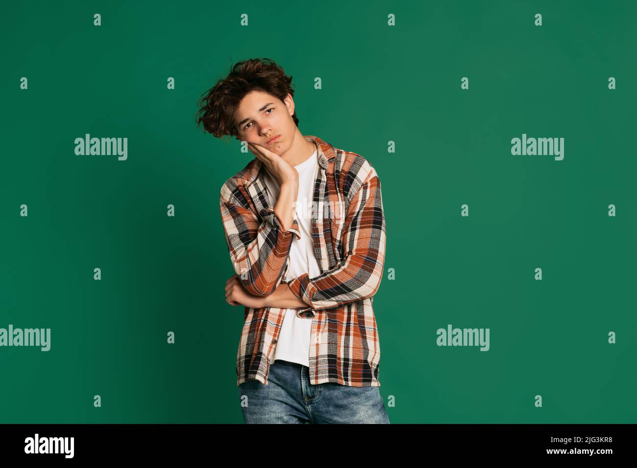 Portrait of sad young boy, teen in casual style clothes posing isolated ...