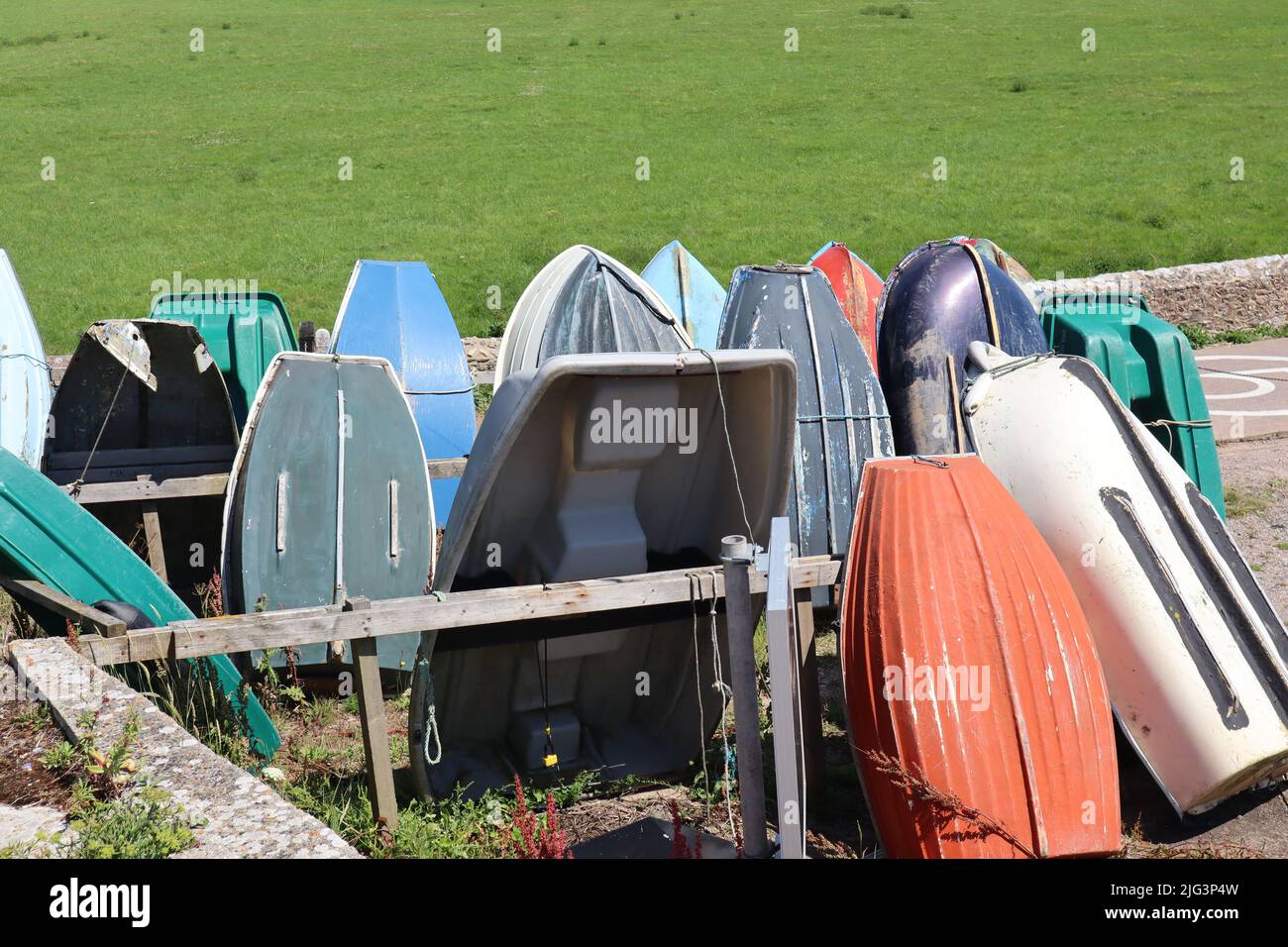 AXMOUTH, DEVON,ENGLAND - JULY 12TH 2020: Upturned rowing boats by the ...