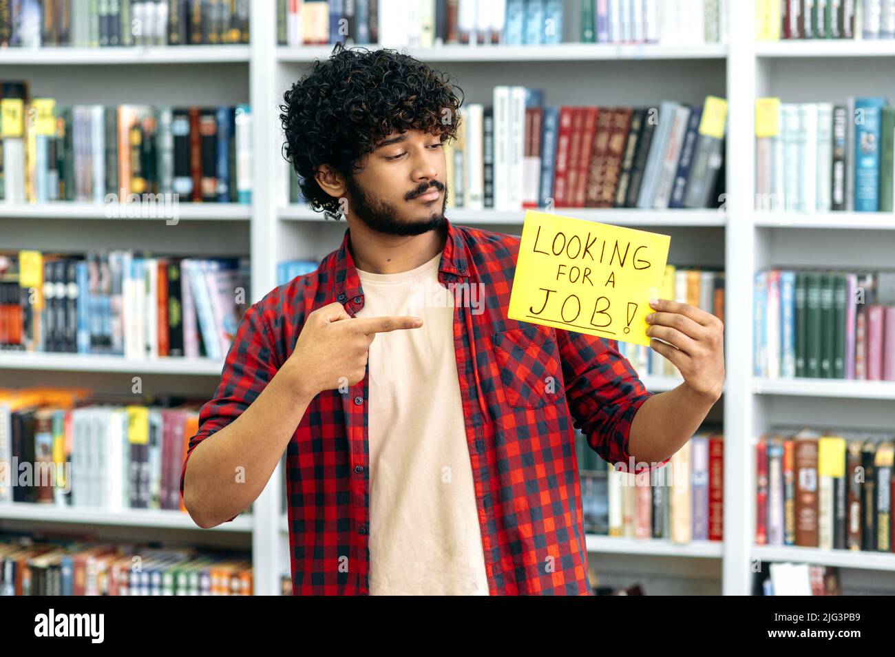 Indian man looking at sign hi-res stock photography and images - Alamy