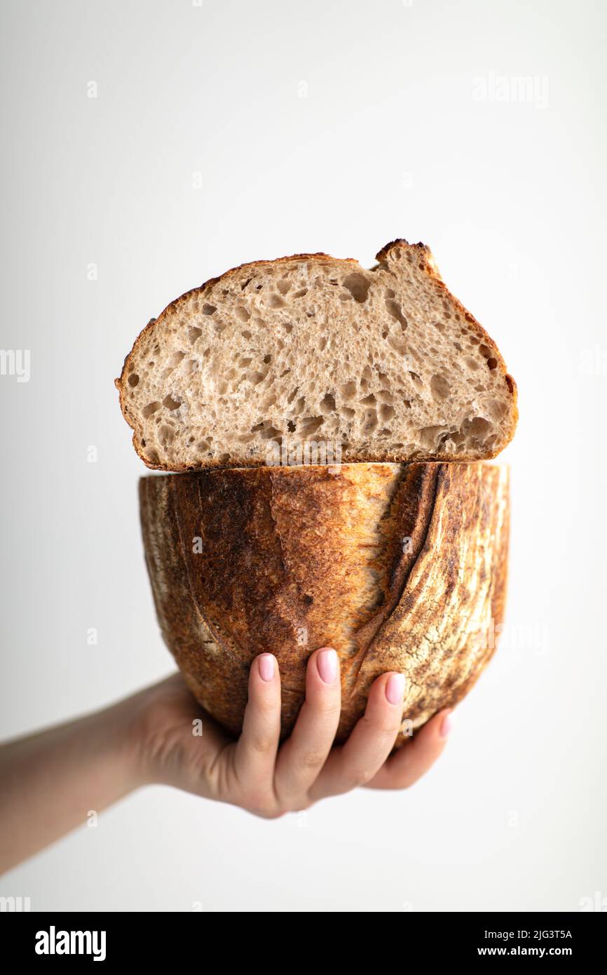 Two half of bread in a hand Stock Photo - Alamy