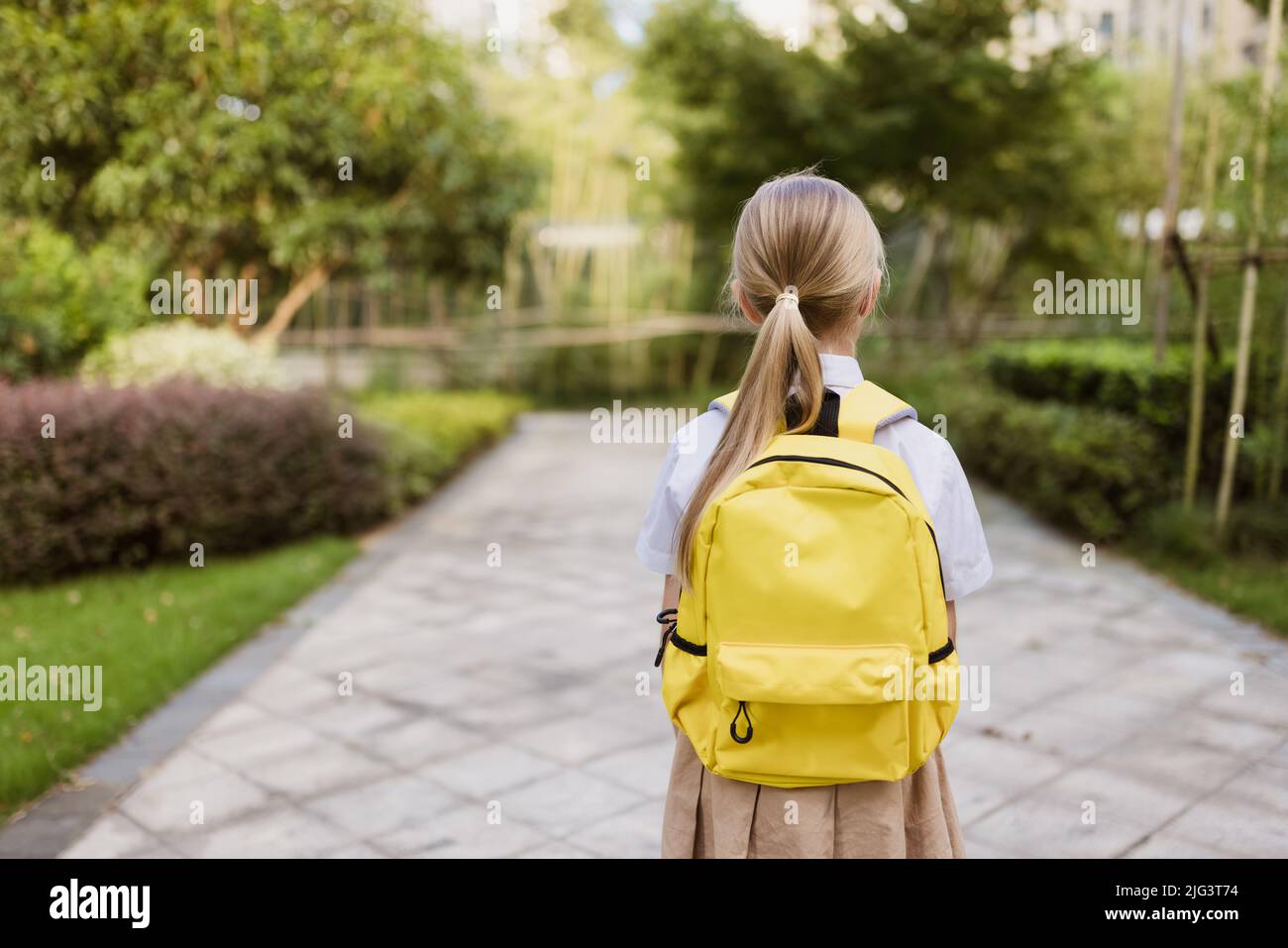 Schoolgirl back to school after summer vacations. Pupil in uniform ...