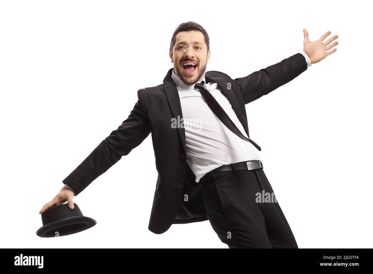 Cheerful guy in a suit dancing and singing isolated on white background ...