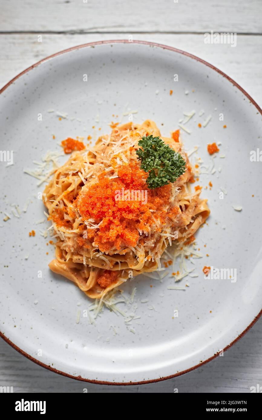 creamy sauce pasta with ebiko , selective focus Stock Photo - Alamy