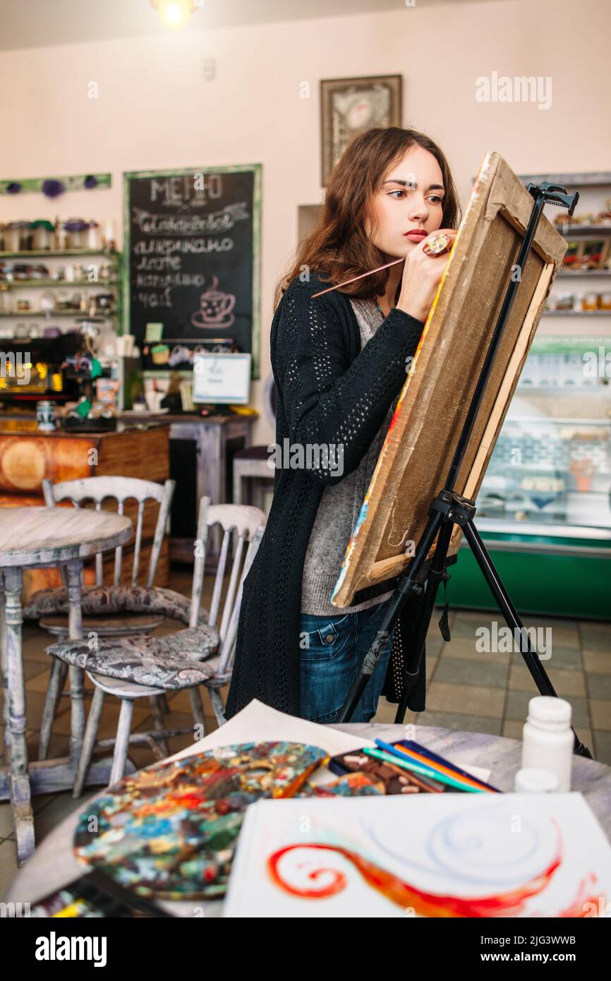 Artist creates painting in workshop interior Stock Photo - Alamy