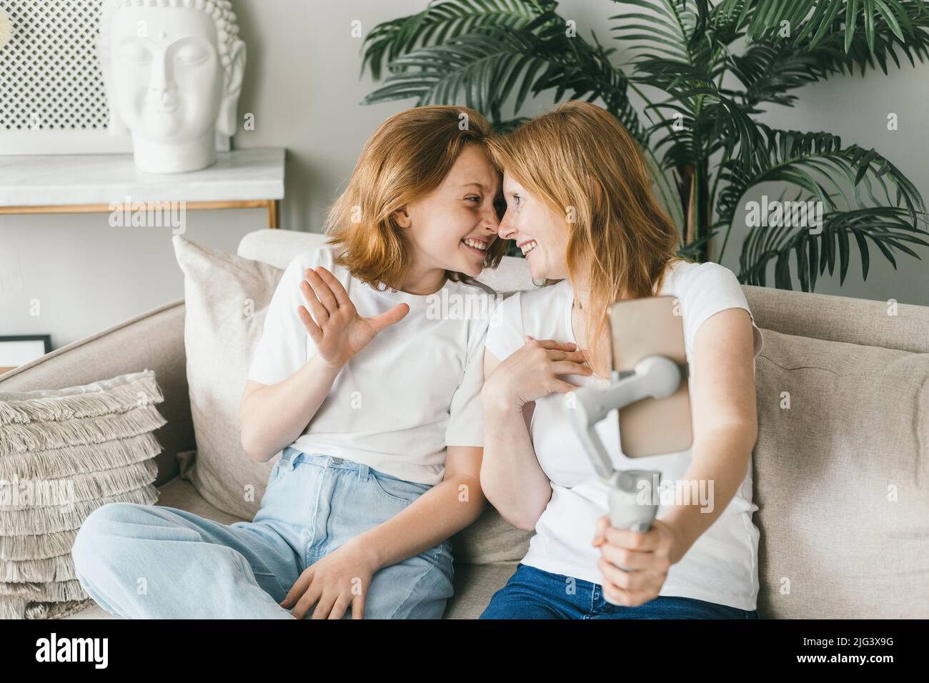 The teenage girl pressed her forehead against her mother's face Stock ...