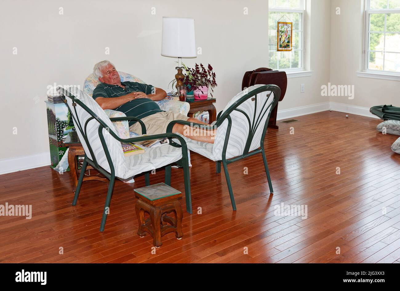 Senior man asleep in chairs hi-res stock photography and images - Alamy