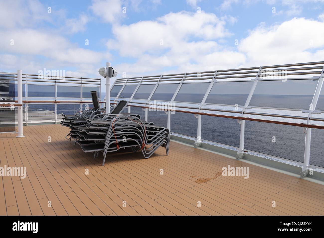 Stack of loungers on an empty cruise ship deck Stock Photo - Alamy