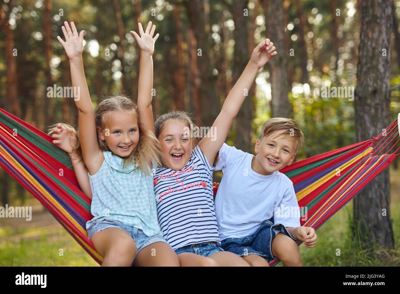 Fun in the garden kids playing in colorful hammock Stock Photo - Alamy