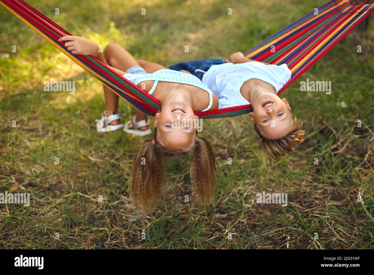 Fun in the garden kids playing in colorful hammock Stock Photo - Alamy