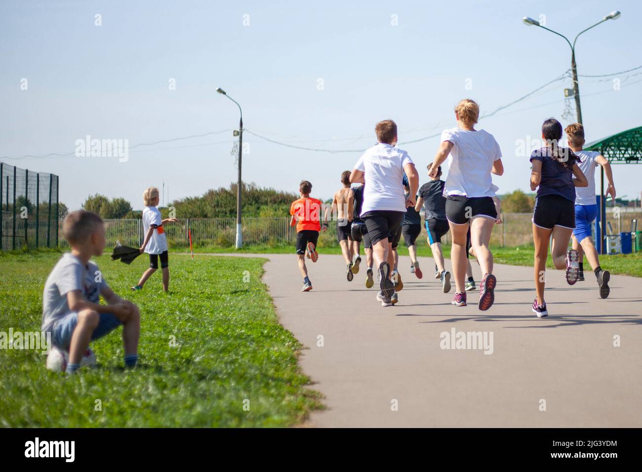 Children compete in running. A lot of kids are racing. Summer sports ...