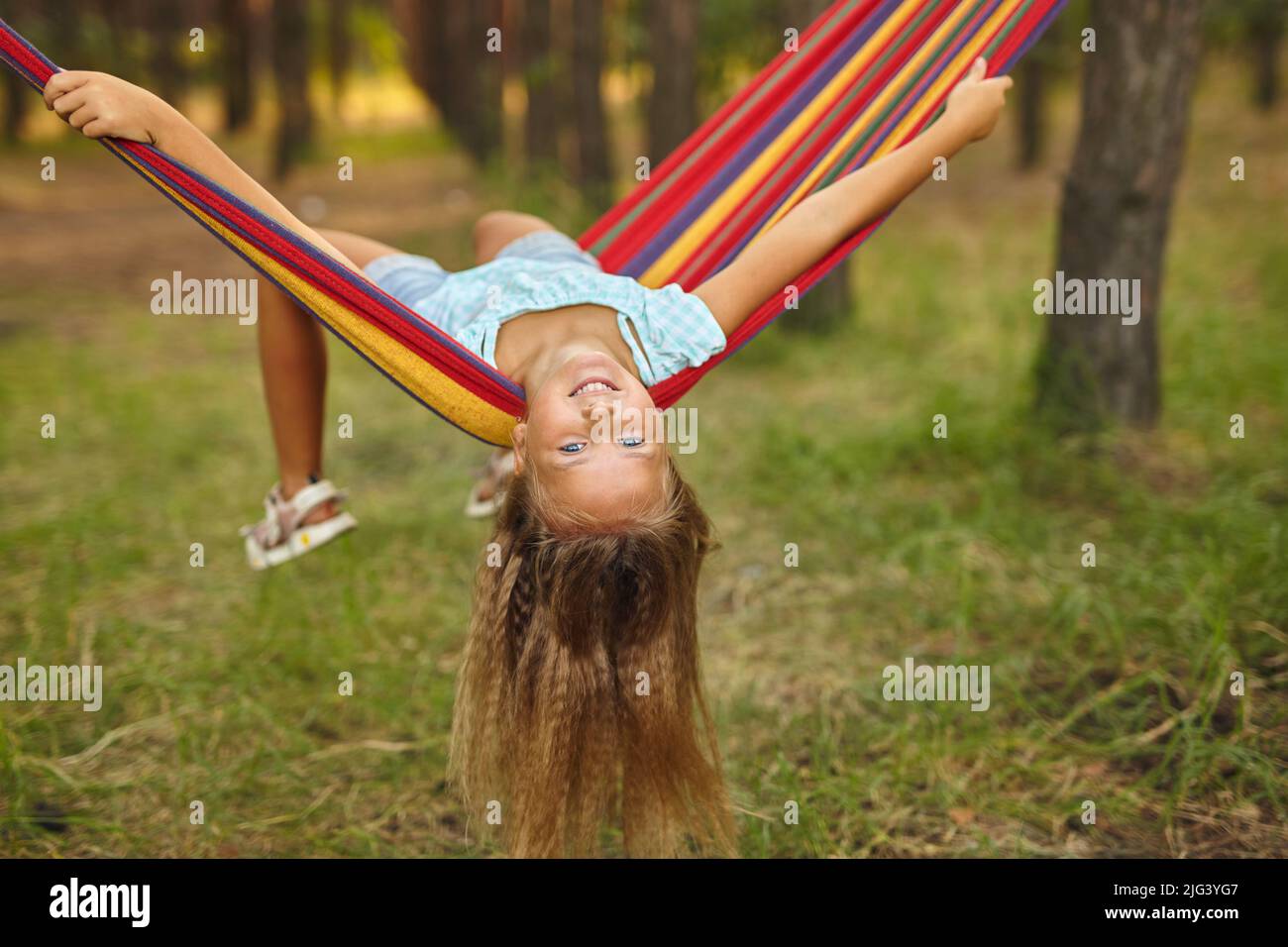 Fun in the garden kids playing in colorful hammock Stock Photo - Alamy