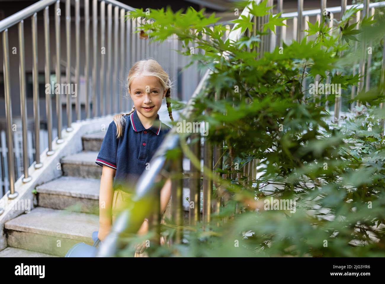 Schoolgirl back to school after summer vacations. Child in uniform ...