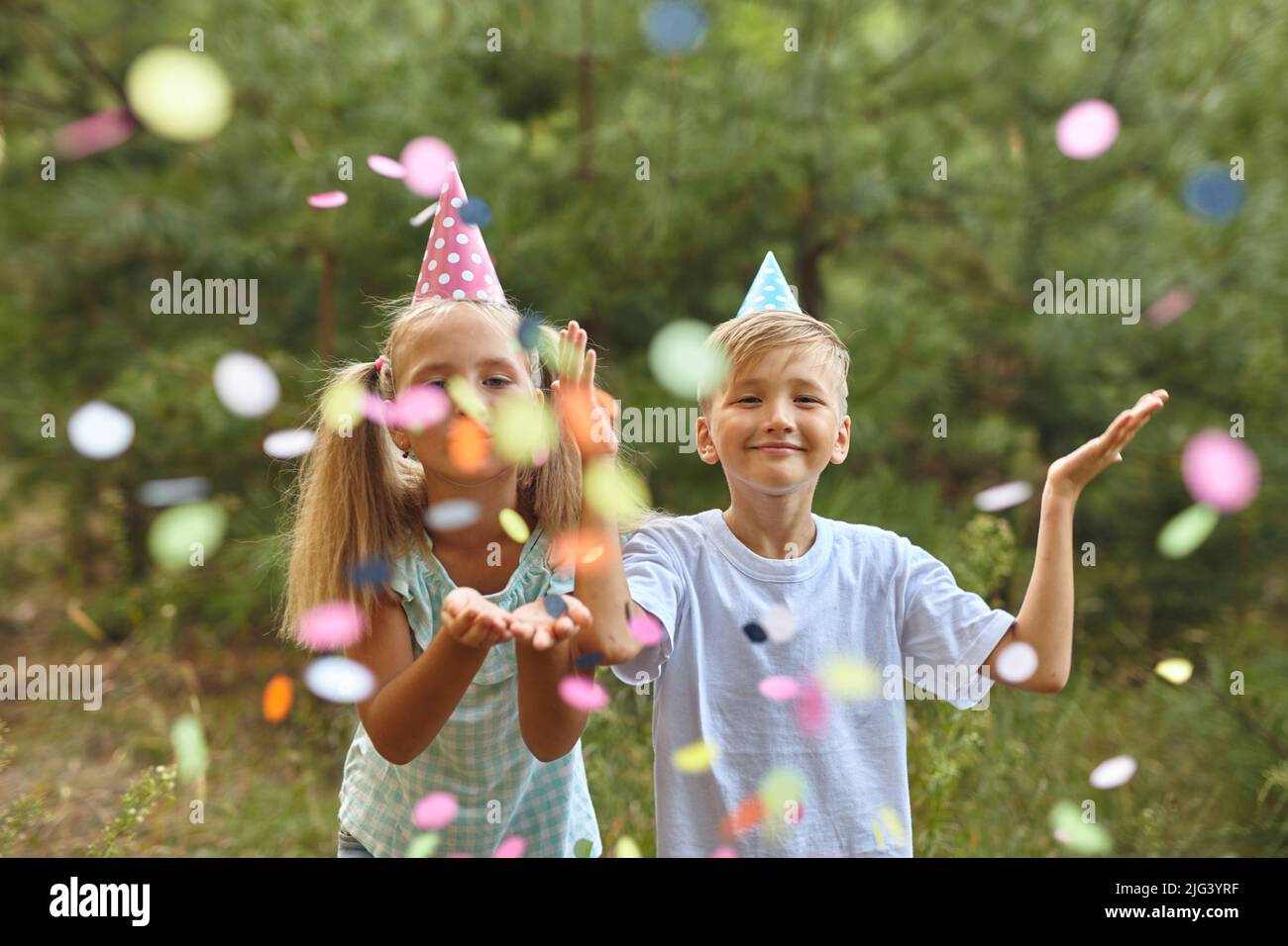 happy birthday children with confetti on outdoor bithday party Stock ...