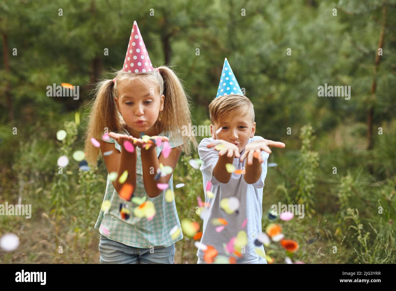 happy birthday children with confetti on outdoor bithday party Stock ...