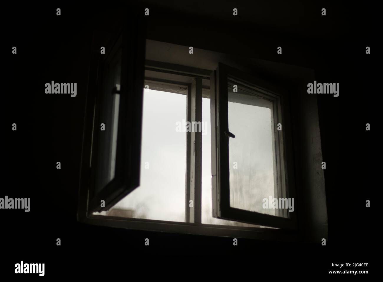 Window is in dark. Open window in building. Old wooden frame with glass ...