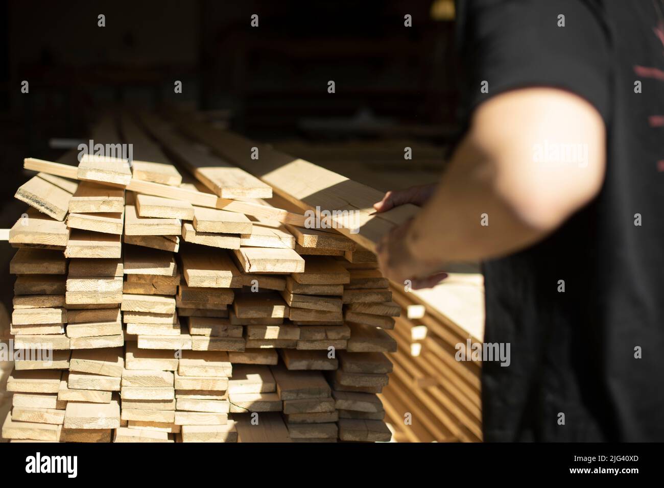 Guy puts boards down. Boards in stock. Building materials Stock Photo ...