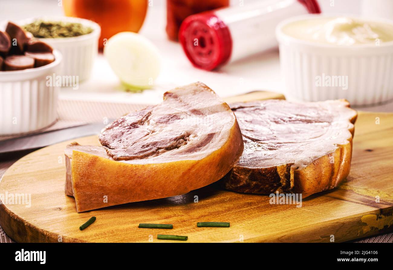 large piece of raw and cooked bacon, brazilian pork with ingredients in ...