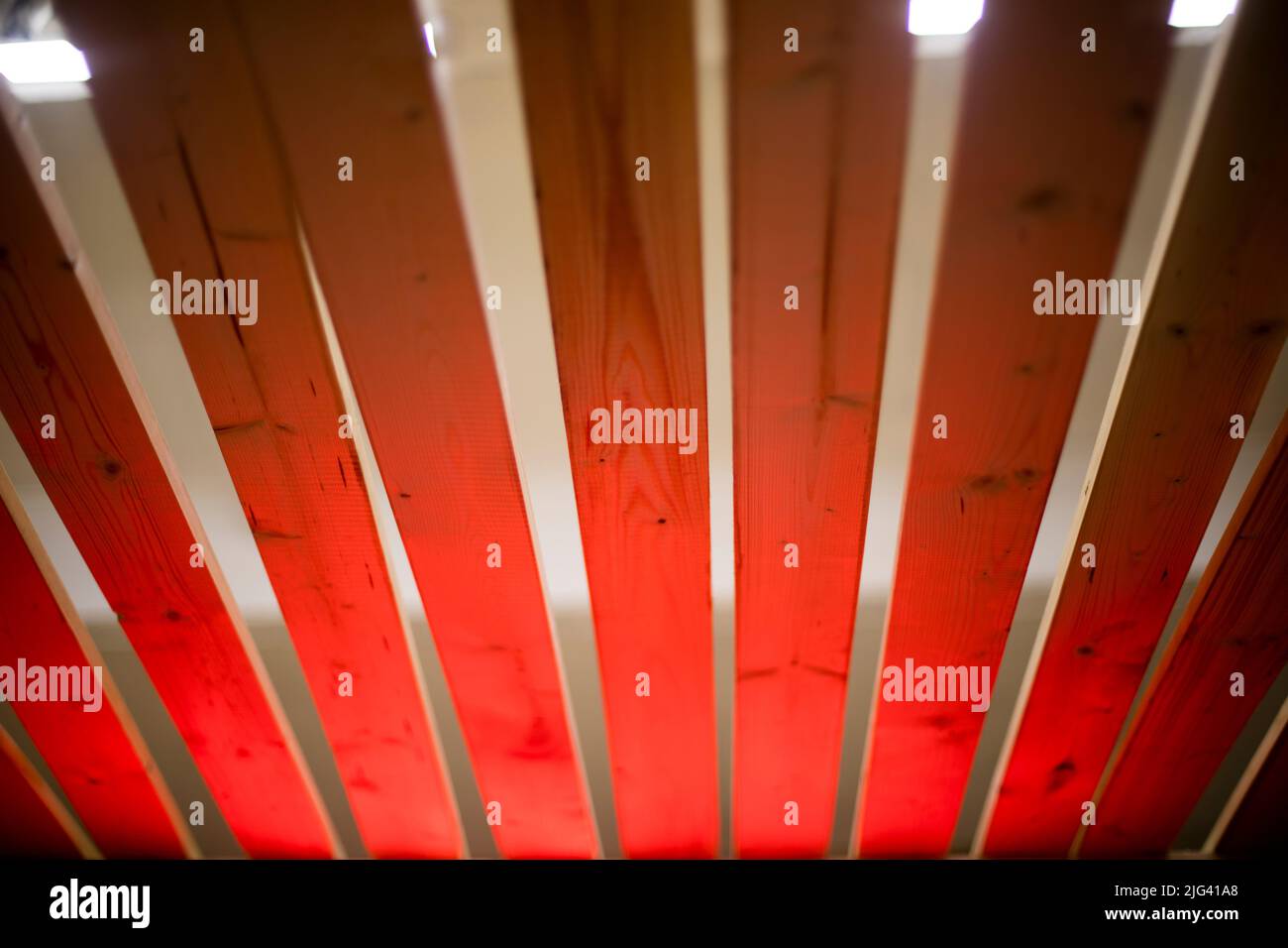 Boards in red light. Neon light on boards. Warehouse of building ...