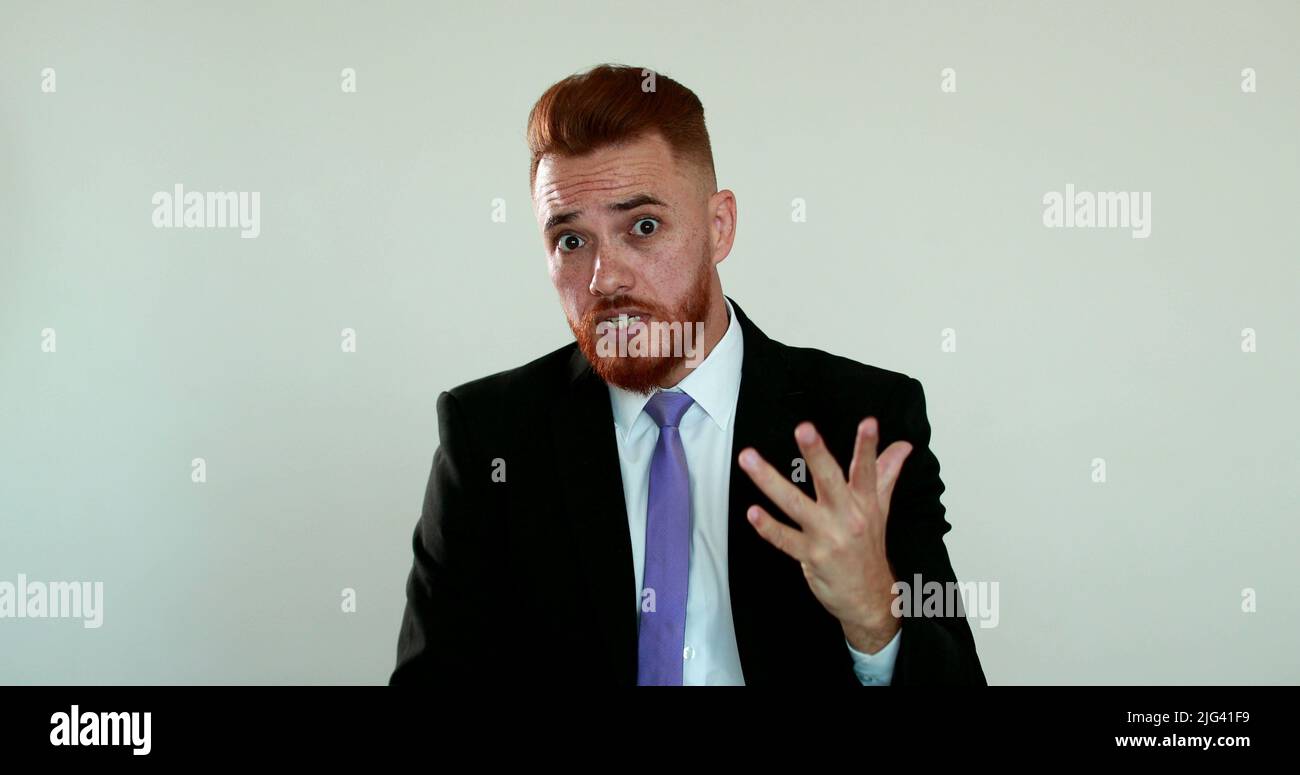 Upset man arguing to camera. Angry business man talking to camera ...