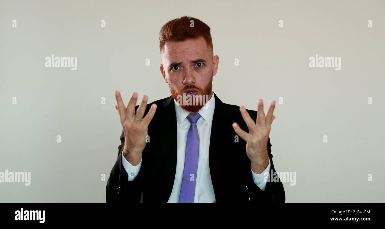 Upset man arguing to camera. Angry business man talking to camera ...