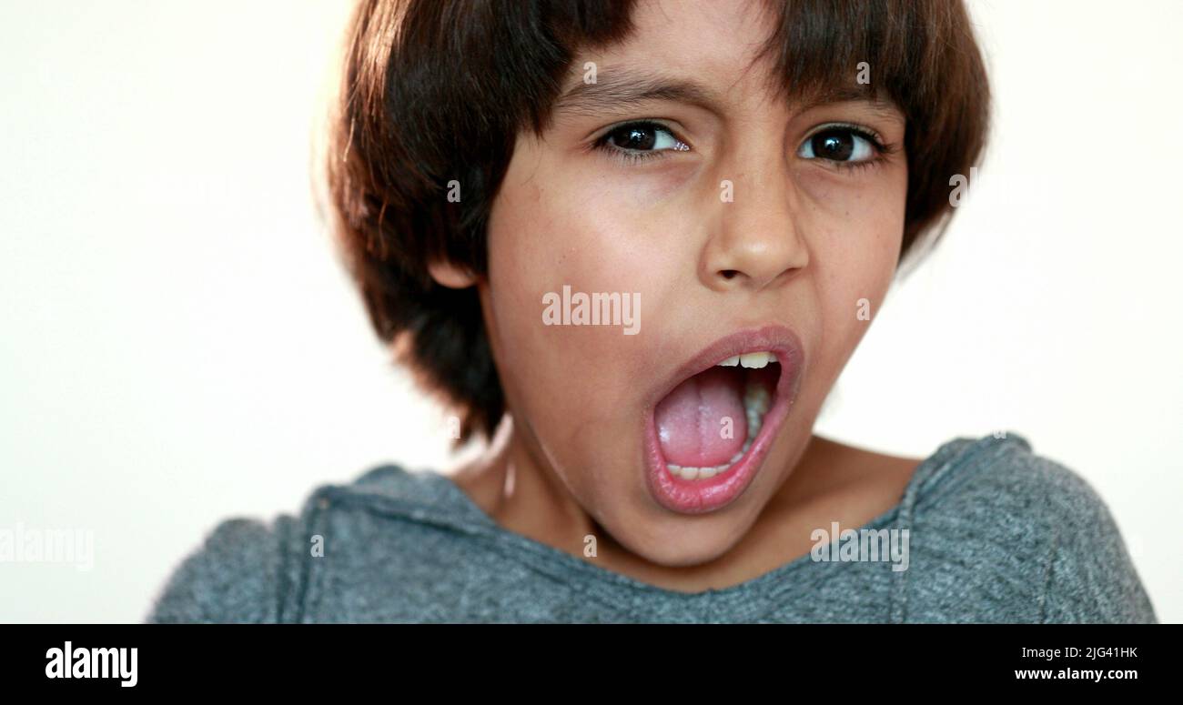 Upset young boy of mixed race crossing arms. Angry child with arms ...
