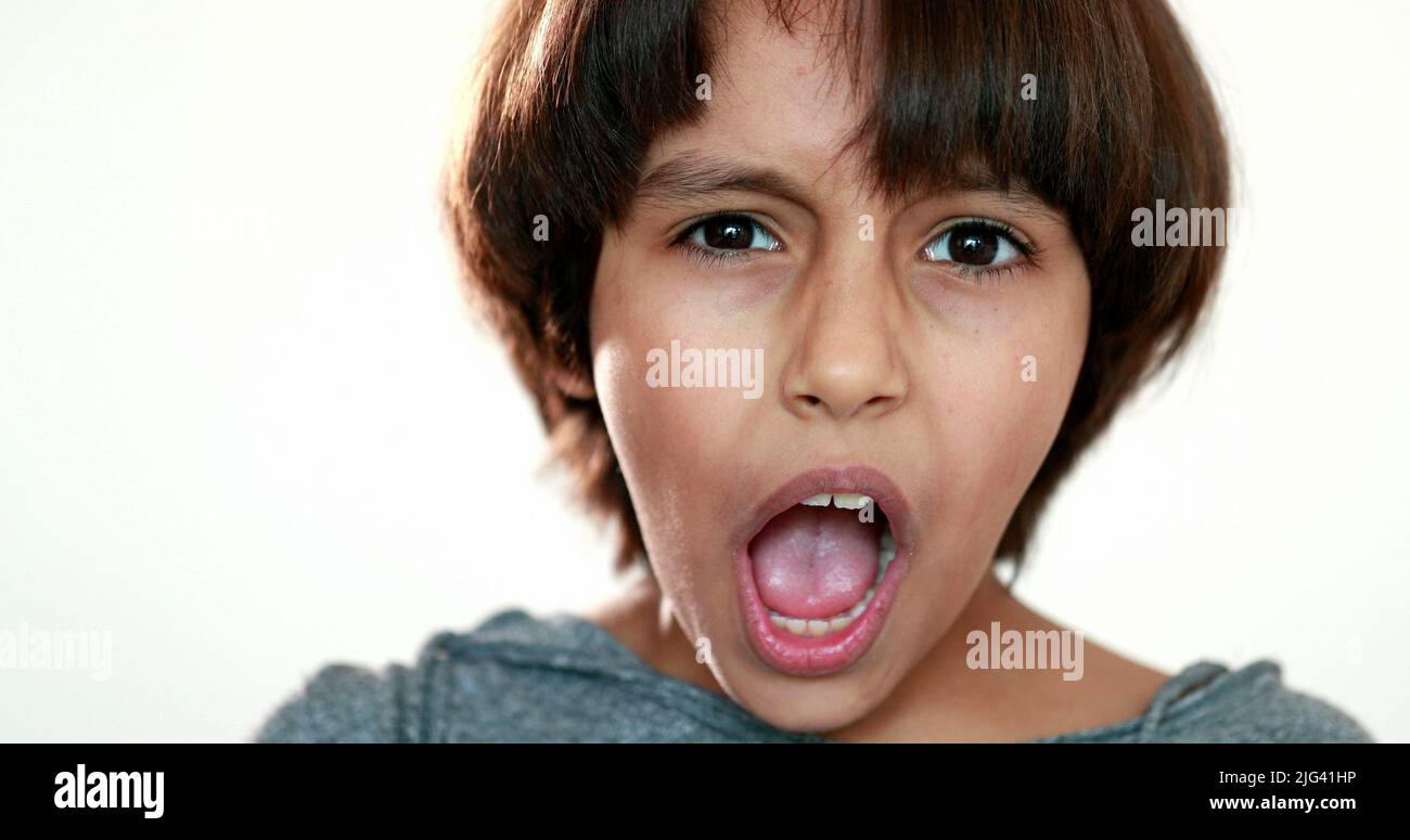 Upset young boy of mixed race crossing arms. Angry child with arms ...
