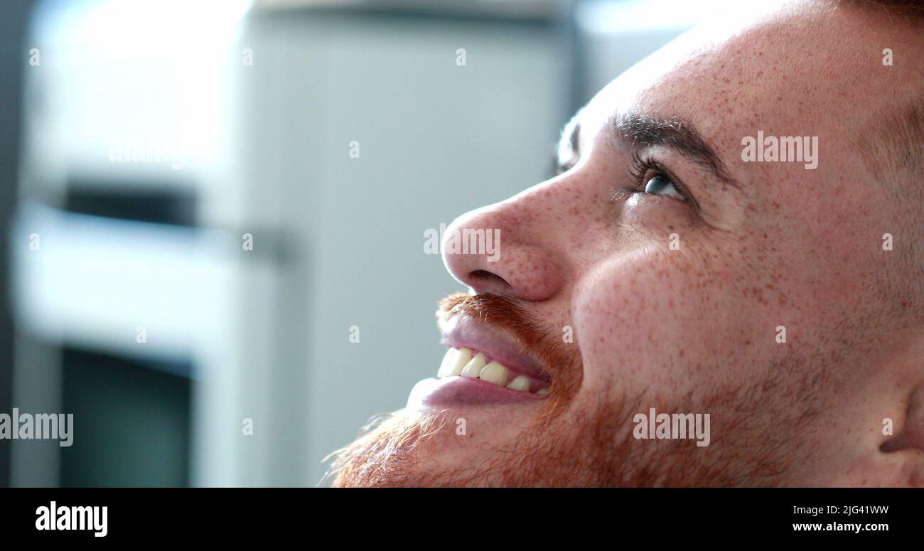 Young man face eyes in meditation and contemplation loooking up with ...