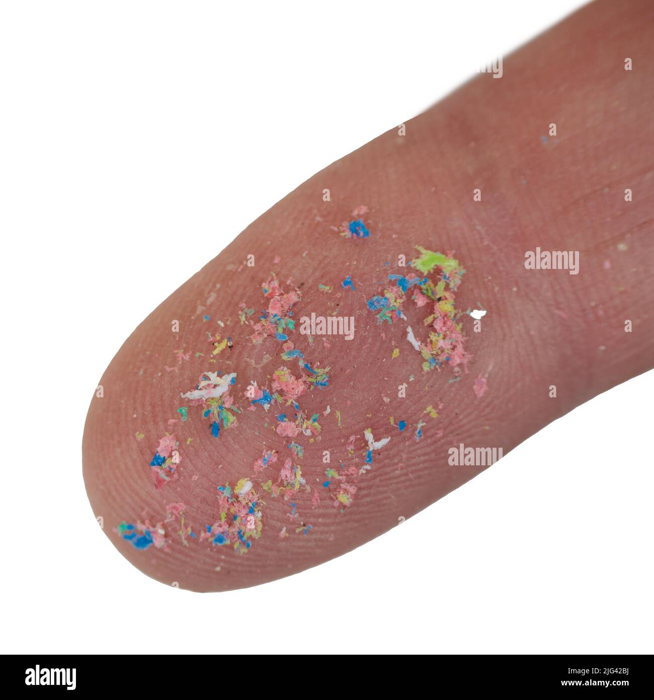 Macro close-up of a microplastic on the finger of the hand. Isolated on ...