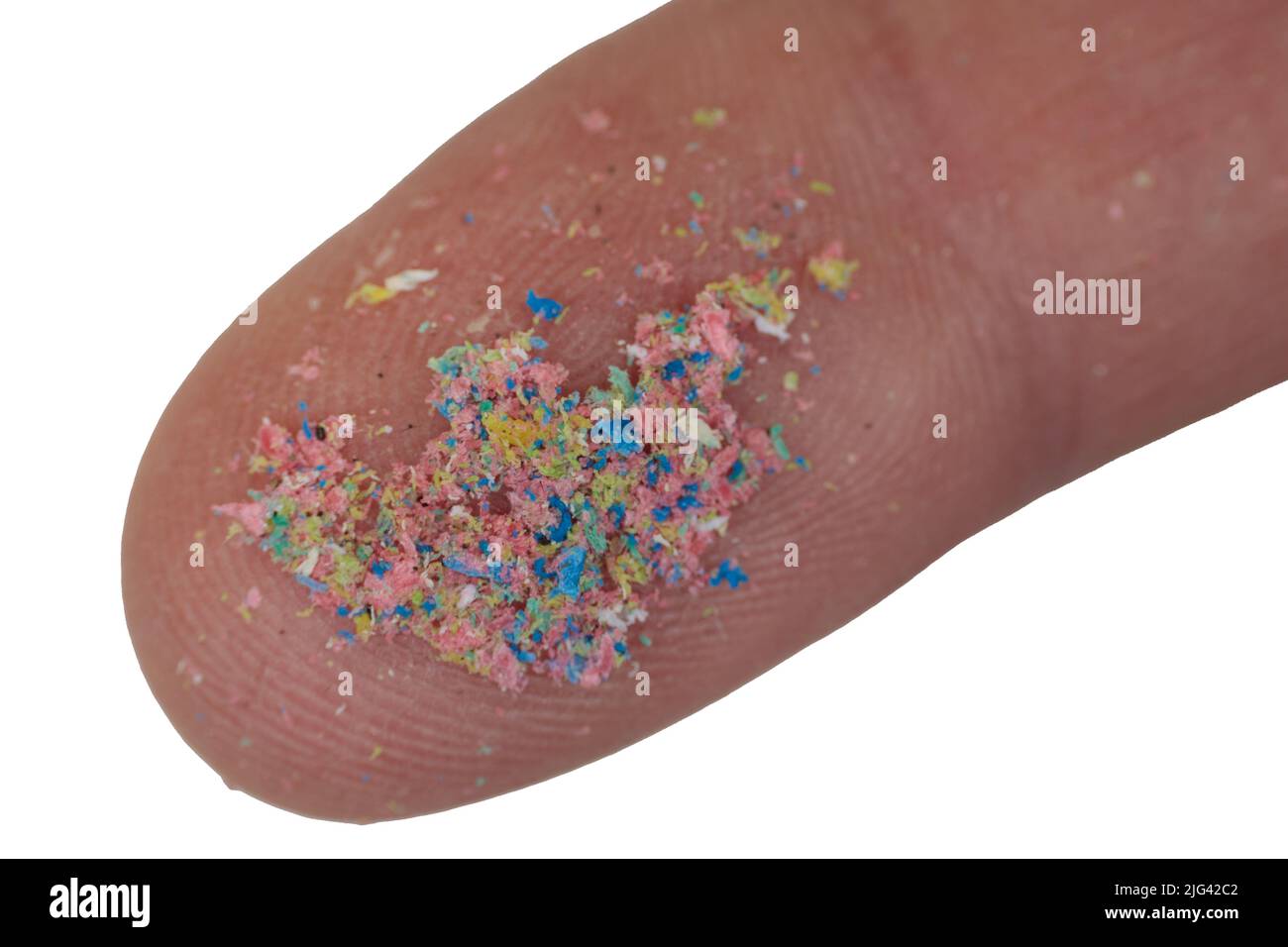 A close-up of the very fine micro plastic on the finger. Environmental ...
