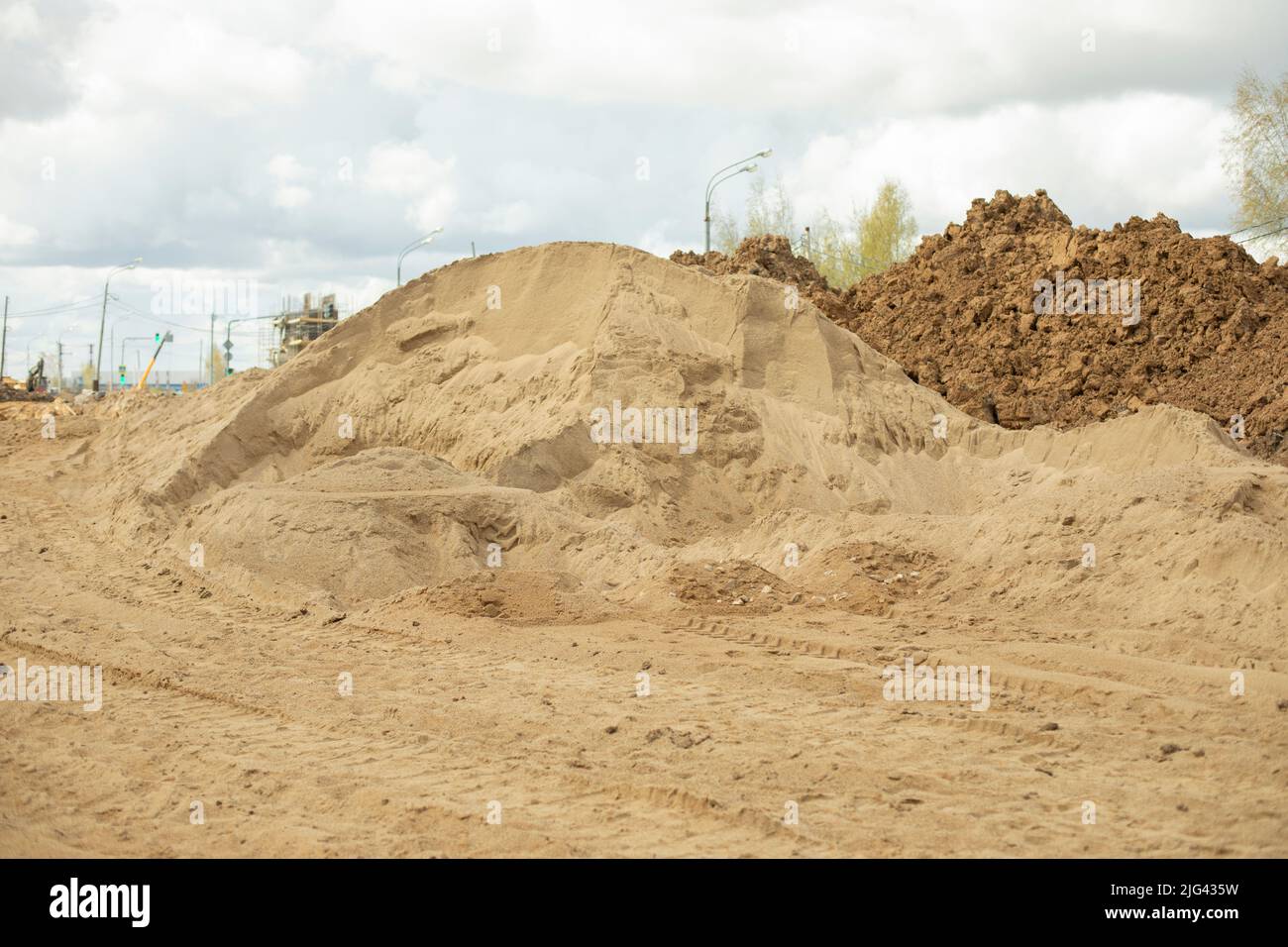 Sand on construction site. Building material is piled up in heap ...