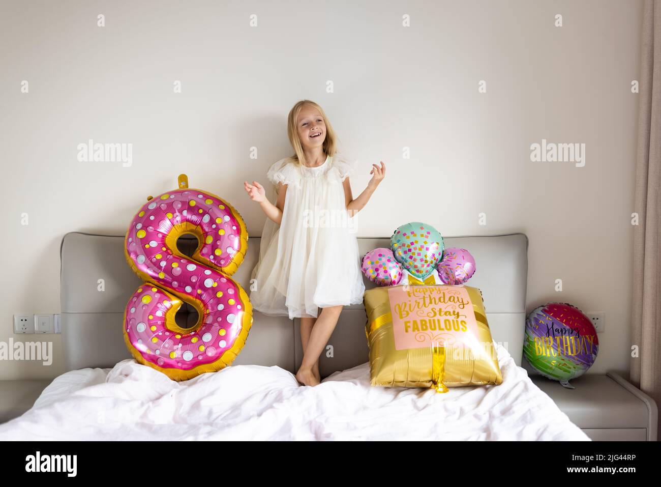 Indoor shot of pretty joyful cute adorable girl kid celebrating eight ...