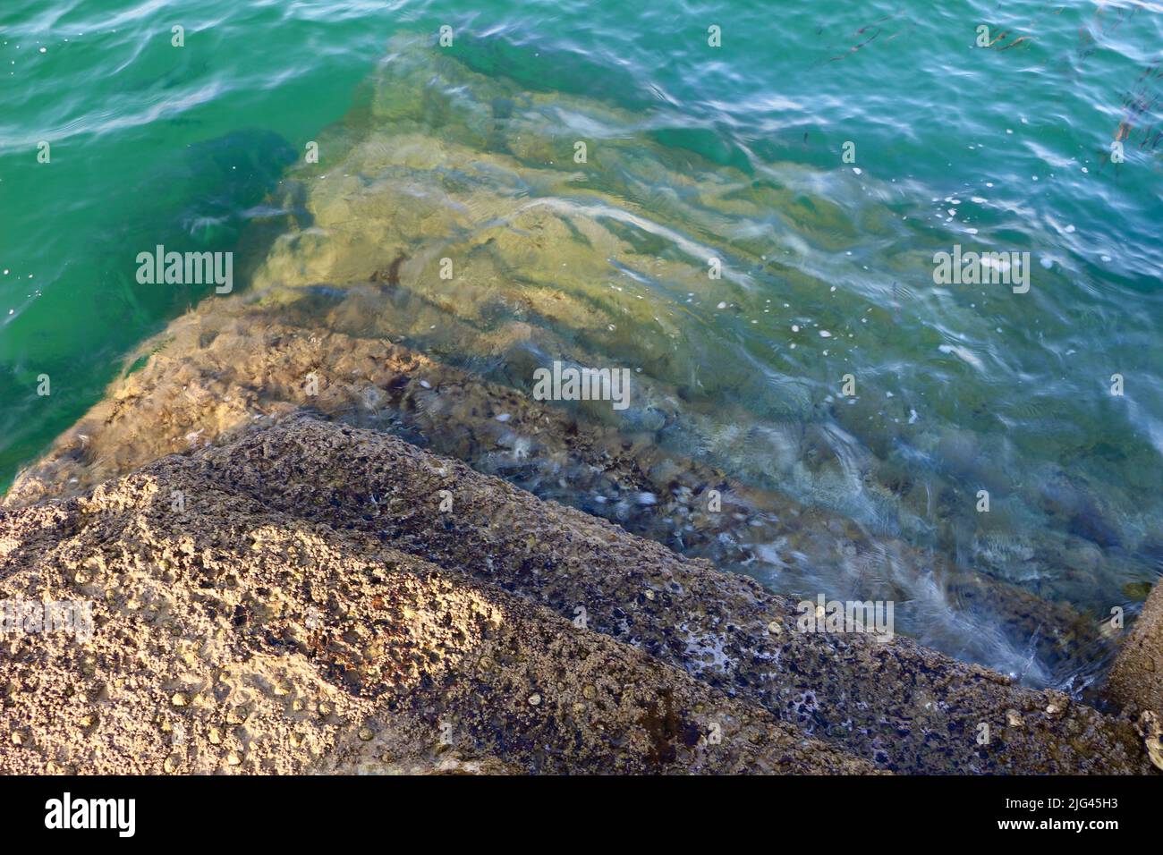 Concrete steps leading down to the sea from a jetty Stock Photo - Alamy