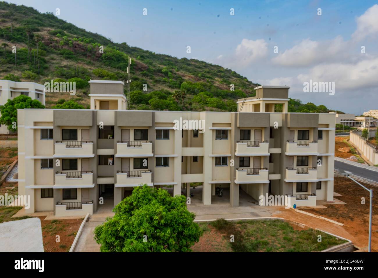 Top view of an Indian colony with bitumen road , building looking in ...