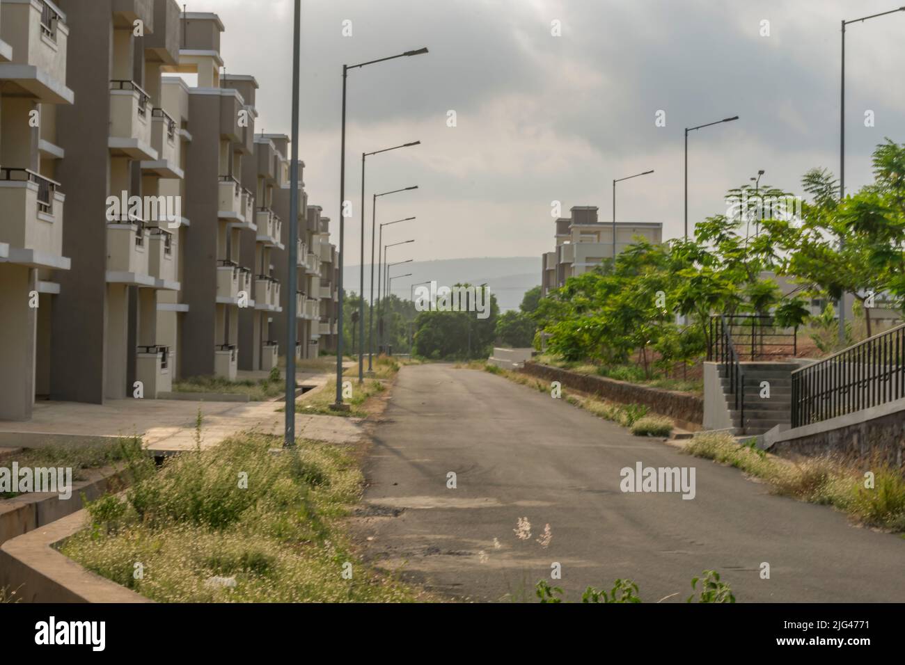 Top view of an Indian colony with bitumen road , building looking in ...