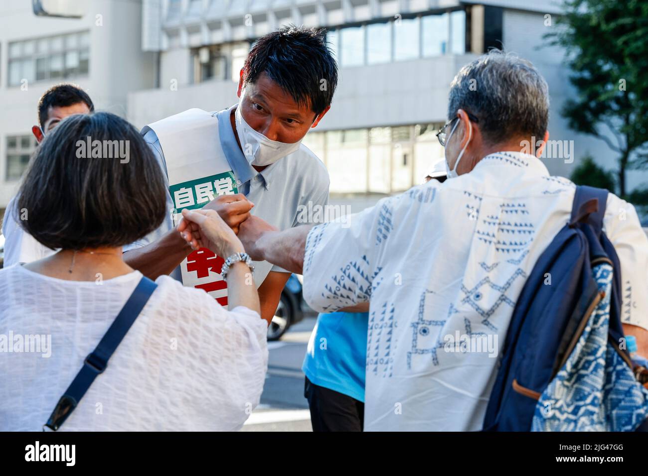 Kentaro Asahi greets pedestrians outside Tokyo Dome on July 7, 2022, in ...