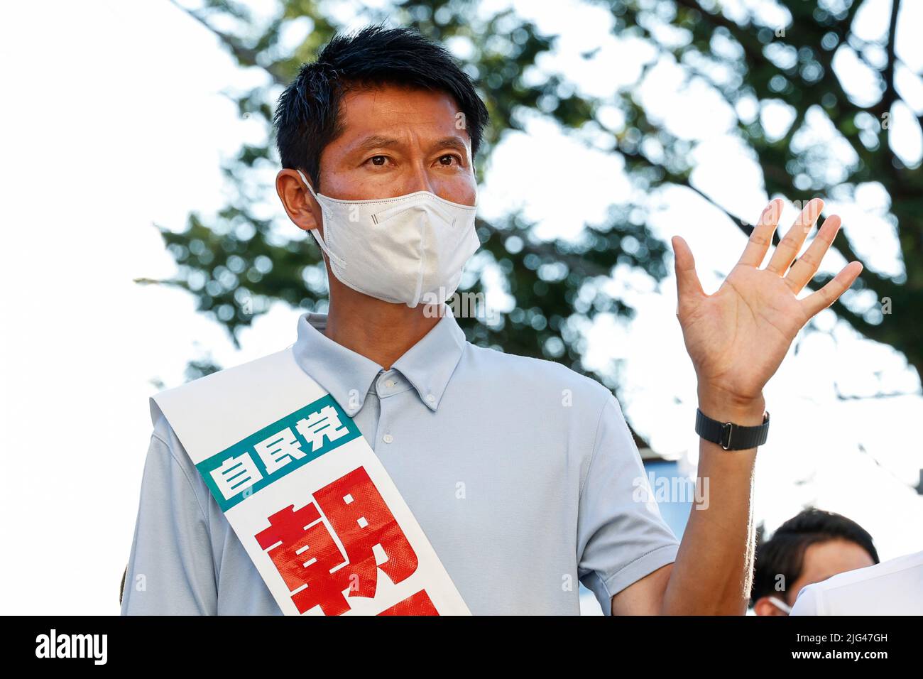 Kentaro Asahi greets pedestrians outside Tokyo Dome on July 7, 2022, in ...