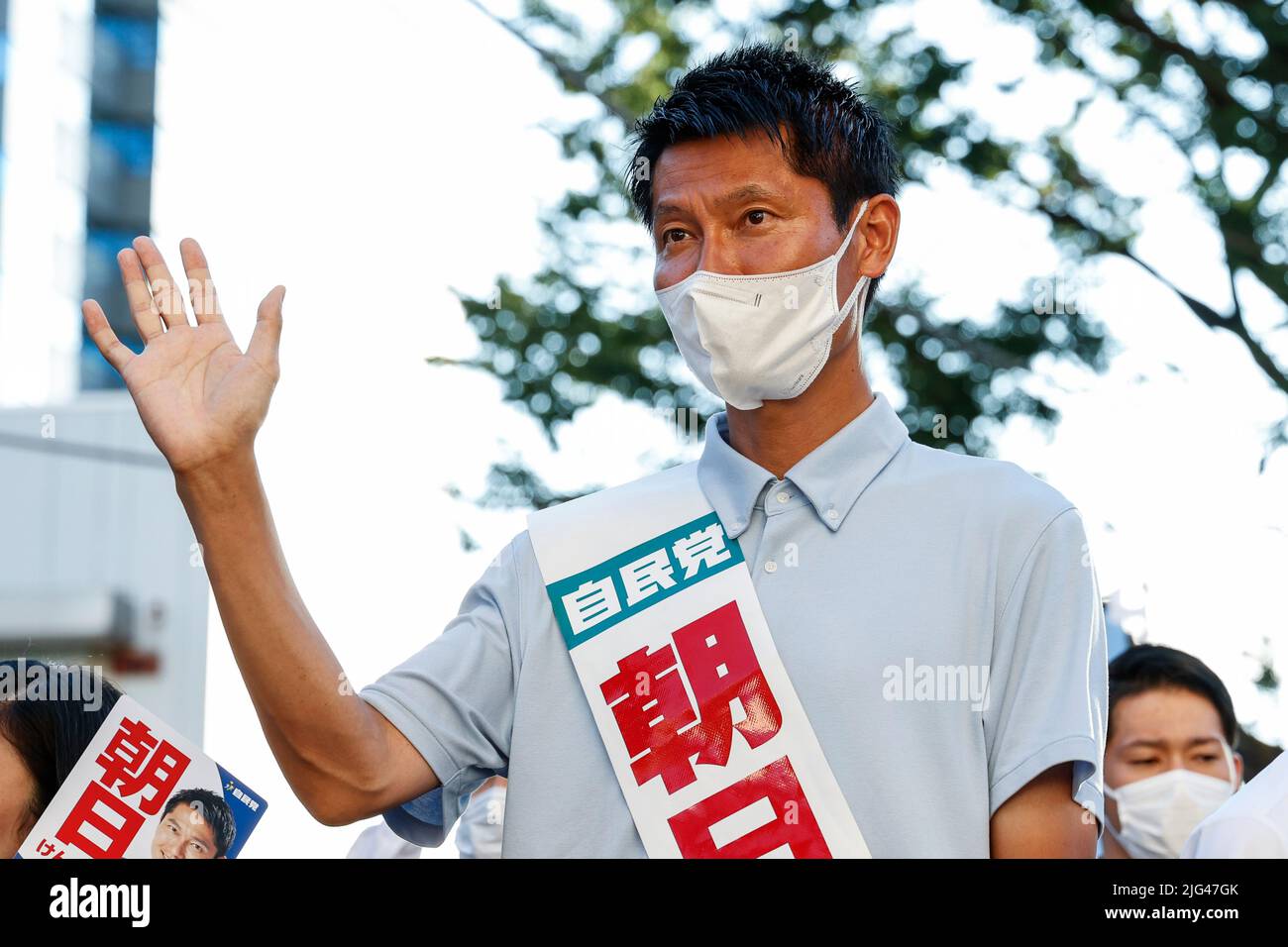 Kentaro Asahi greets pedestrians outside Tokyo Dome on July 7, 2022, in ...