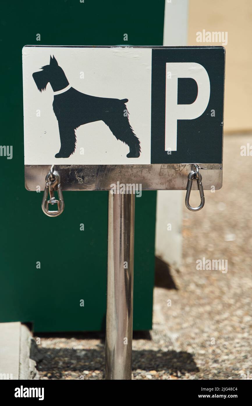Designated dog parking sign. Place for bind dogs waiting for owners ...
