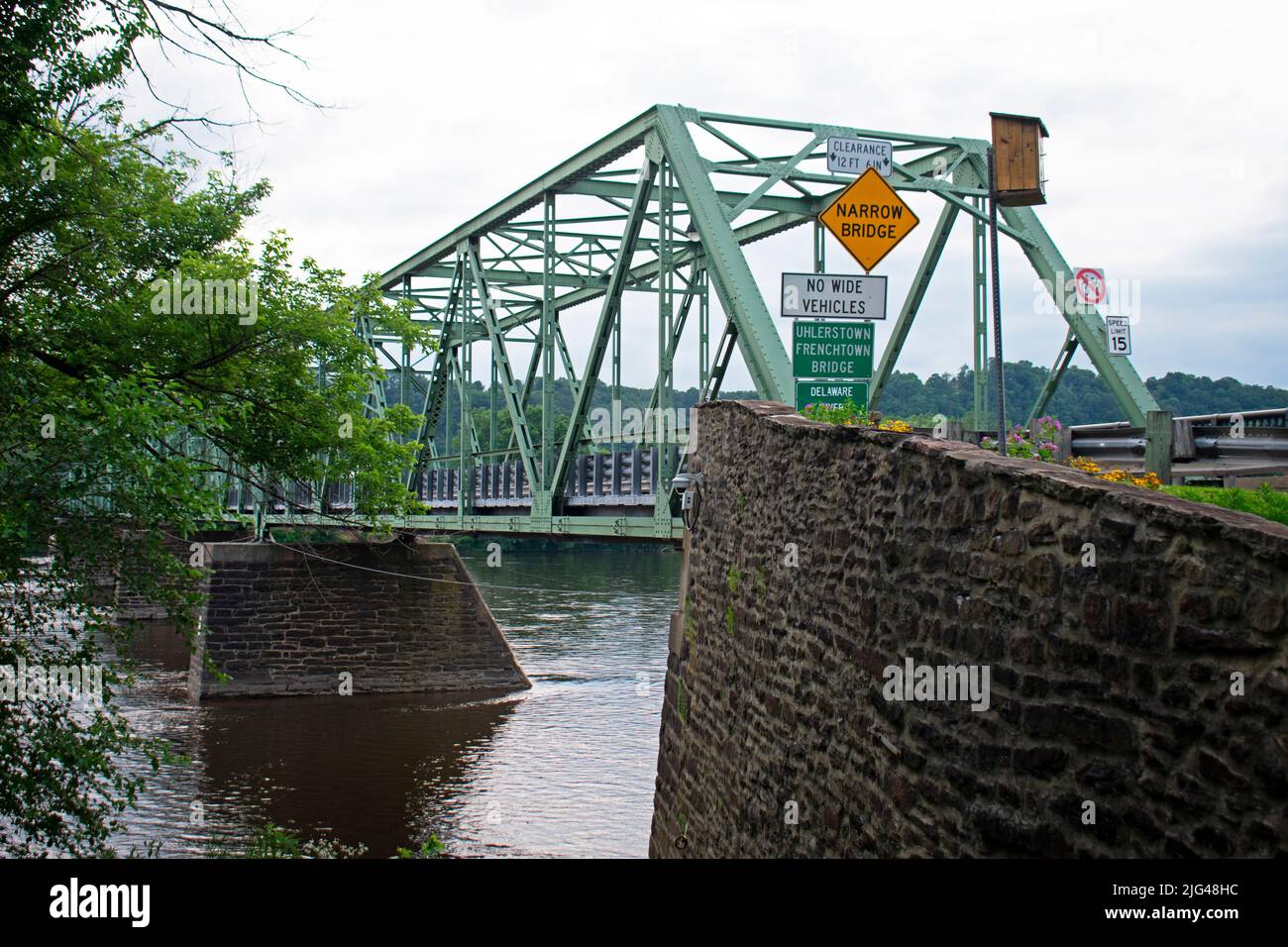 Narrow metal truss bridge crossing the Delaware River between the towns ...