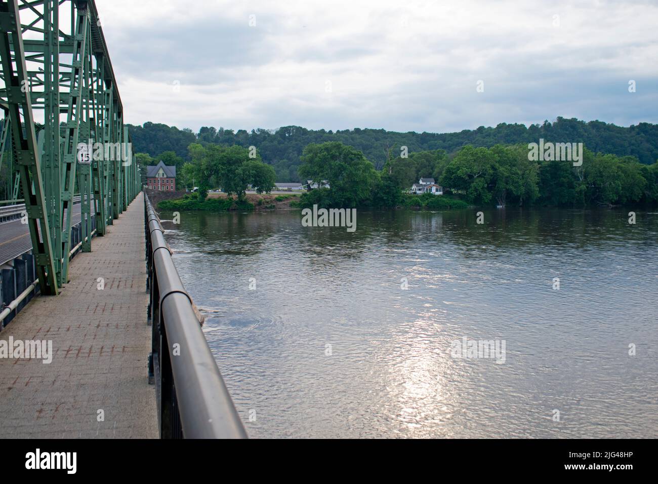 Narrow metal truss bridge crossing the Delaware River between the towns ...