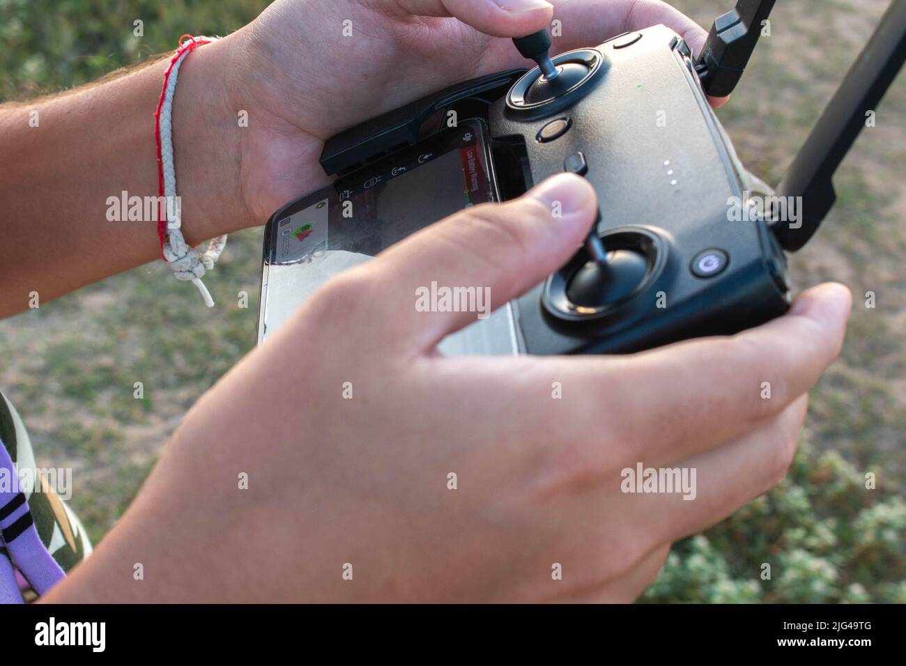 manly hands using a drone on the beach Stock Photo - Alamy