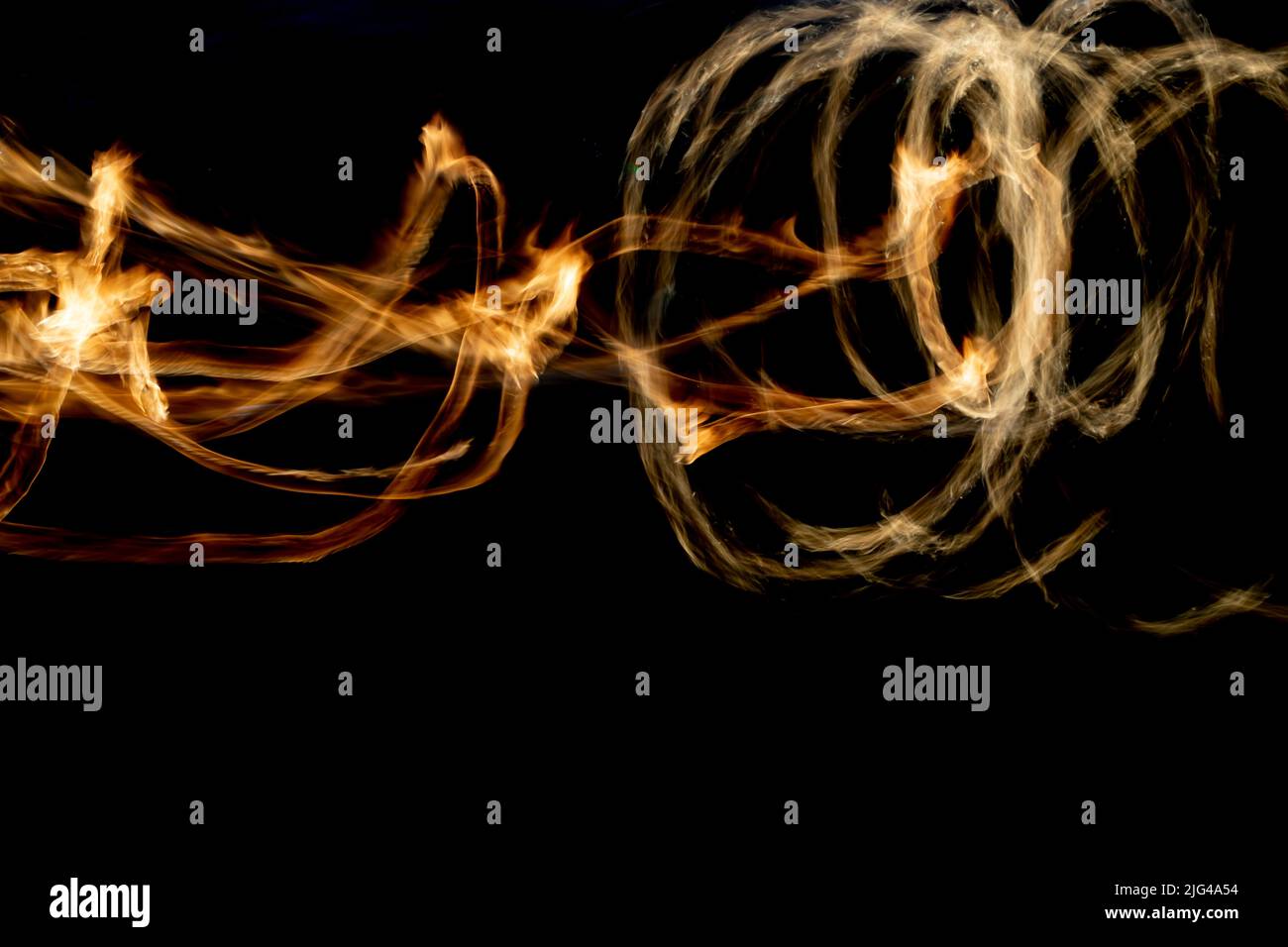 Circles of fire. Lines of flame. Shooting fire show on long shutter ...